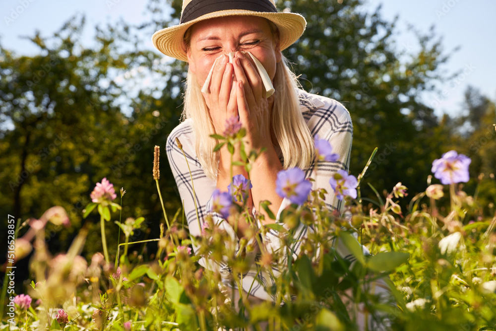 Woman with hay fever in a flowering meadow Stock Photo | Adobe Stock
