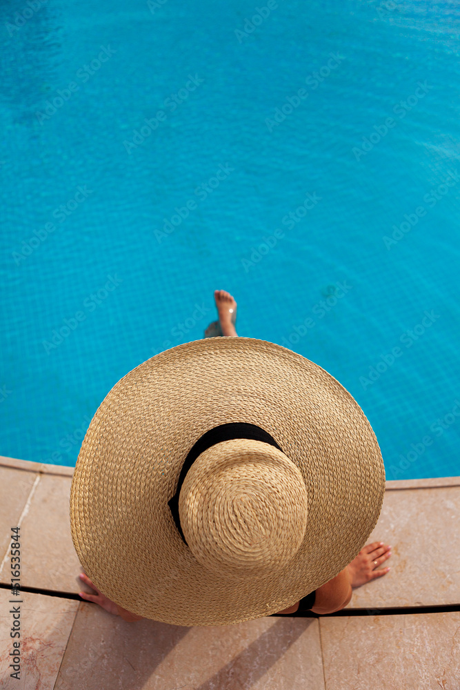 Beautiful woman sunbathing by the pool top view horizontal. Summer ...