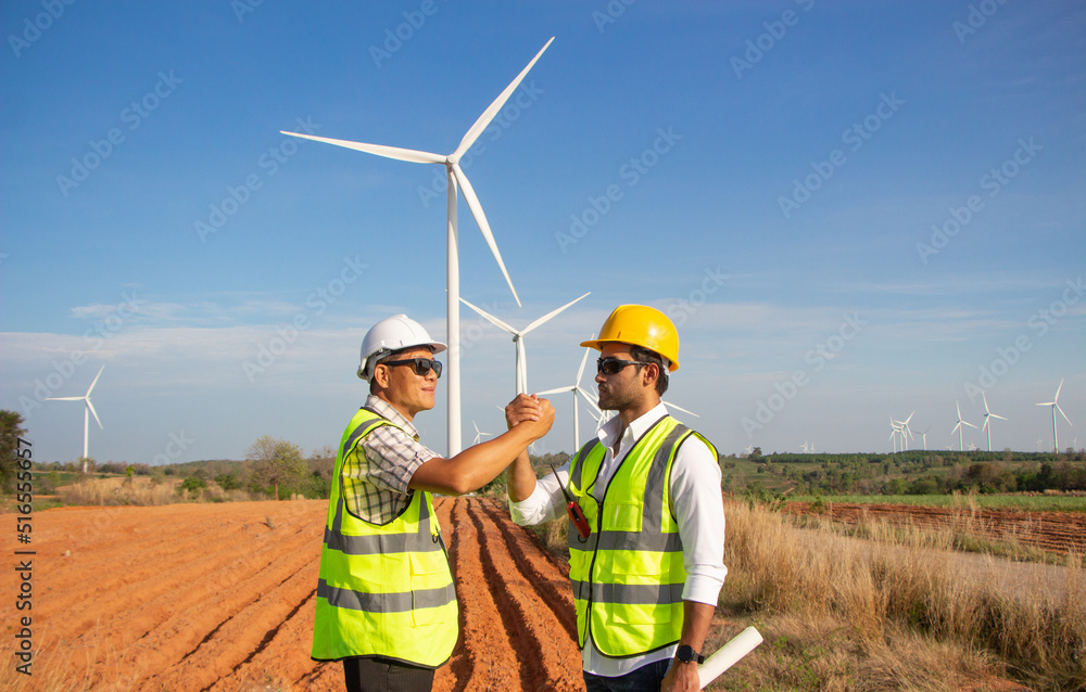 engineer team working in wind turbine farm. Renewable energy with wind ...