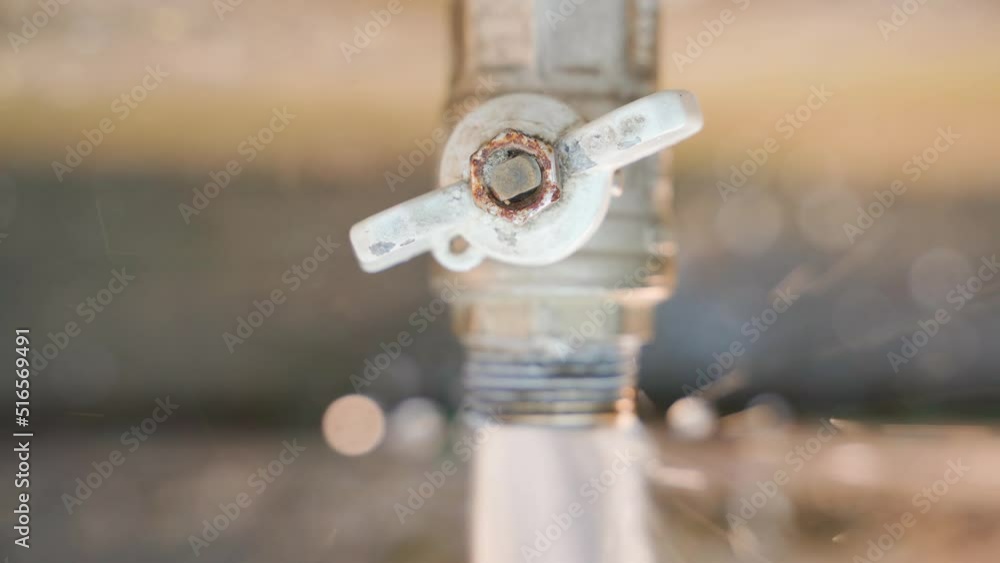 Opening a water valve top view. Hand opens the water in the garden ...