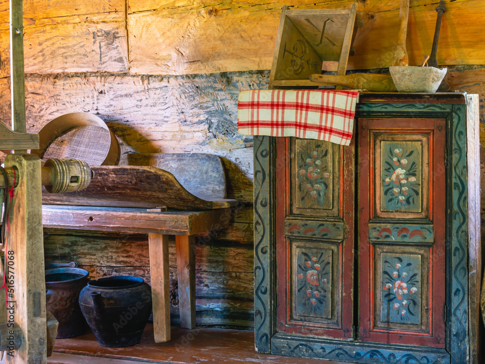 Poster Antique furniture and household items in a rustic log house ...