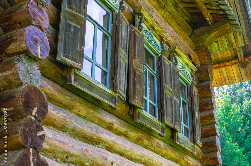 Large diameter logs and windows in a rustic log house built in the 19th ...