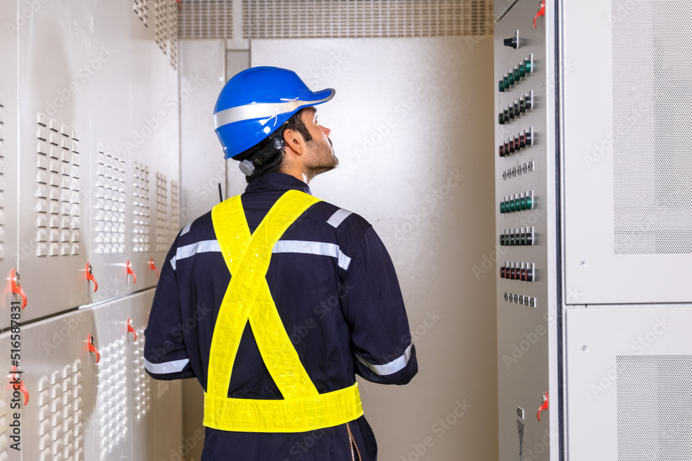 Maintenance engineer inspect relay protection system with laptop tablet ...