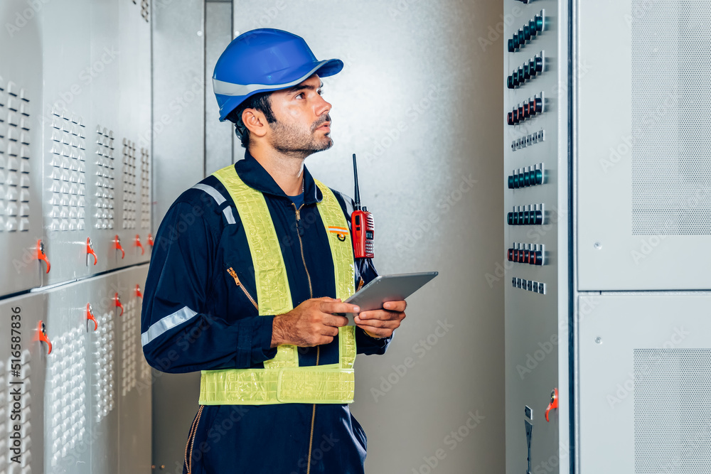 Maintenance engineer inspect relay protection system with laptop tablet ...
