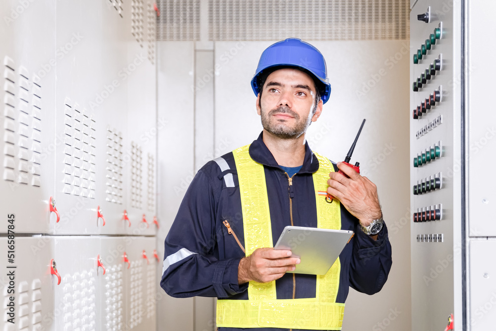 Maintenance engineer inspect relay protection system with laptop tablet ...