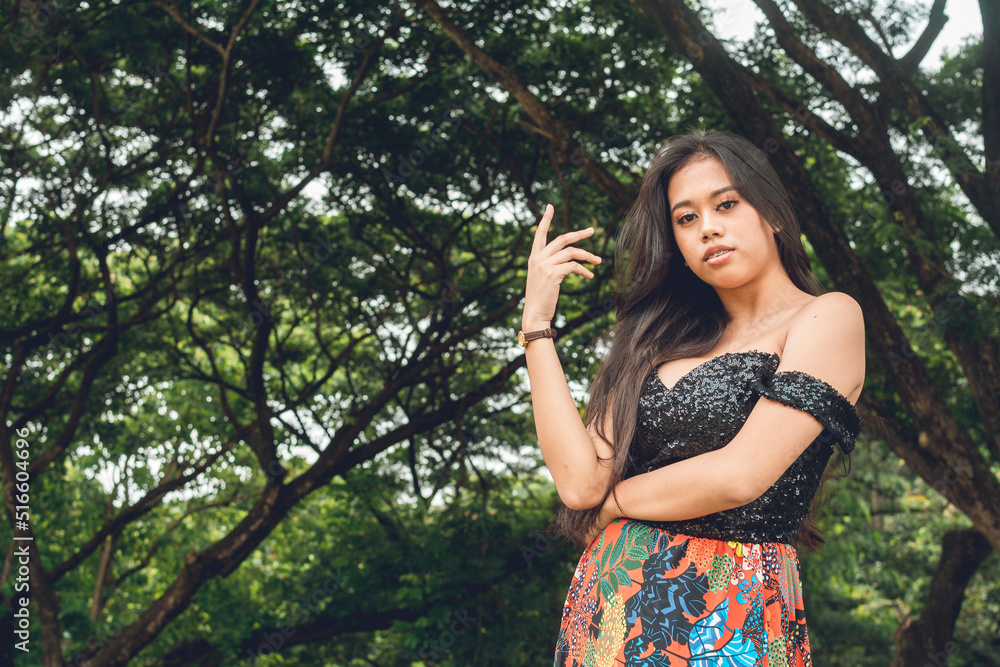 A voluptuous and curvy young Filipina woman posing at the park. A ...