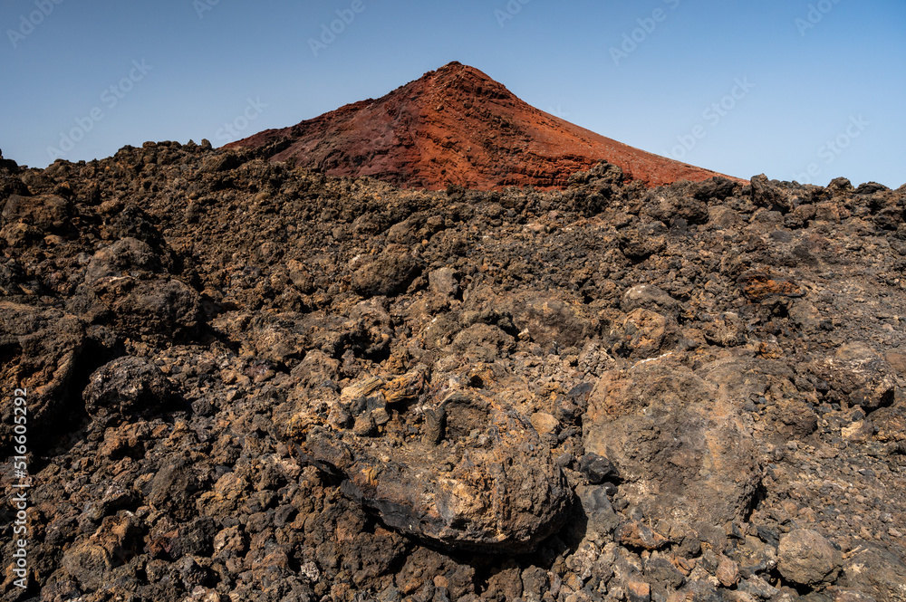 Poster Volcanic rocks formed from lava and a crater of a volcano in ...