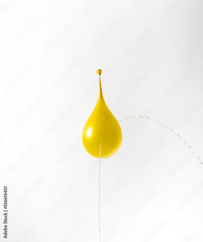 punctured water balloon leaking Stock Photo | Adobe Stock