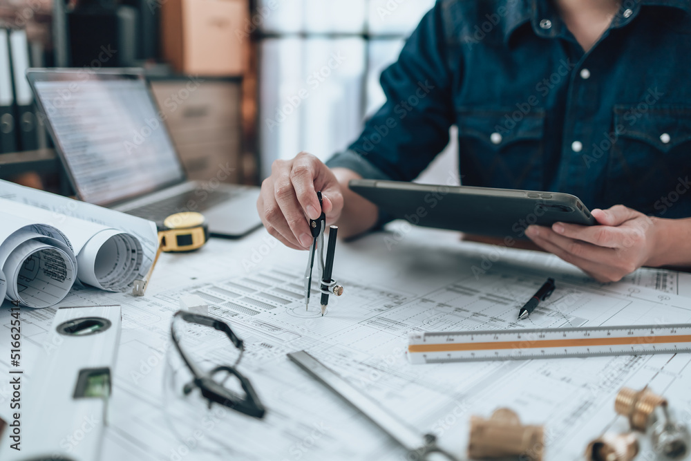 Engineering working with drawings inspection and writing on the office ...