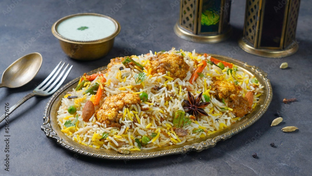 Paneer Butter Masala Biryani with raita served in a dish side view on ...