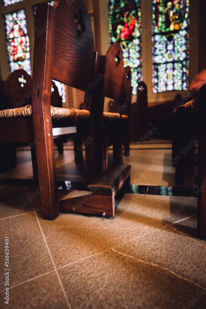 Ground level view of kneeling bench rows in a church used for praying ...