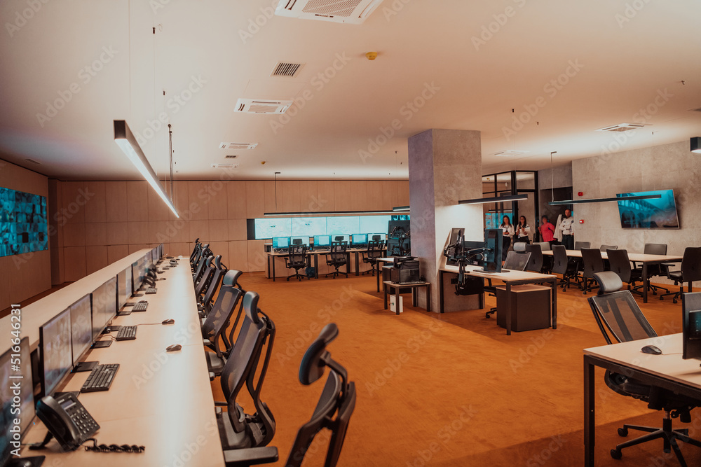 Empty interior of big modern security system control room, workstation ...