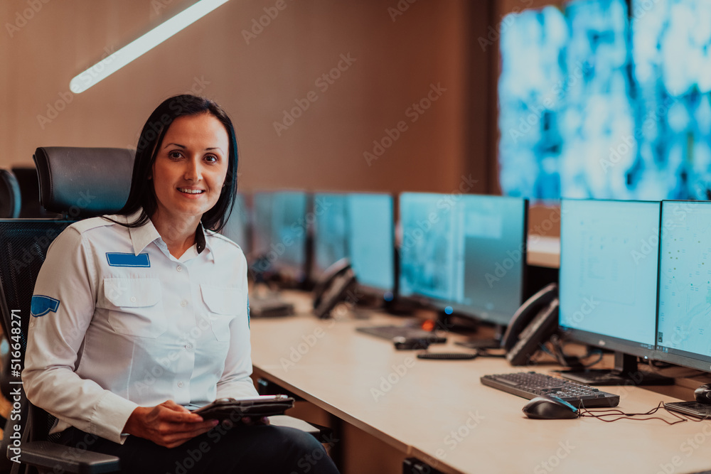 Female security operator working in a data system control room offices Technical Operator ...
