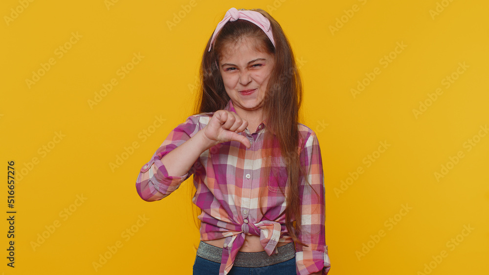 Dislike. Upset young preteen child girl kid showing thumbs down sign ...