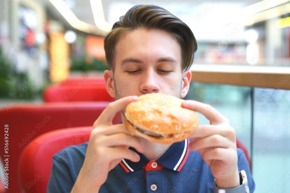 Portrait of young happy positive handsome man, cheerful guy is sitting ...