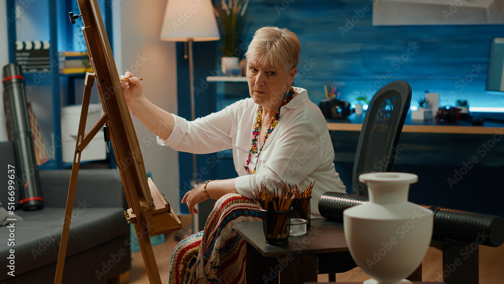 Senior woman drawing artwork sketch with artistic skills and pencils on ...
