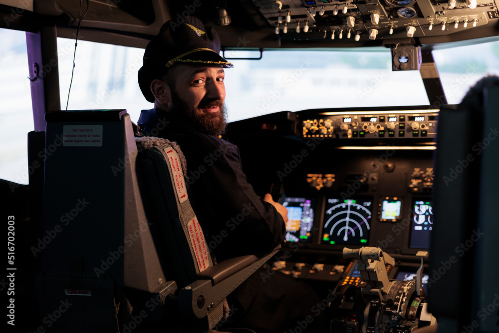 Portrait of professional aviator using cockpit dashboard command to ...