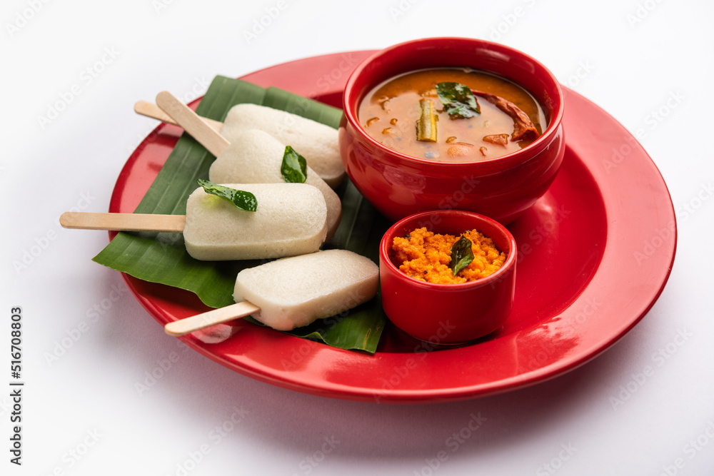 Idly lollipop or idli candy with stick served with sambar and chutney ...