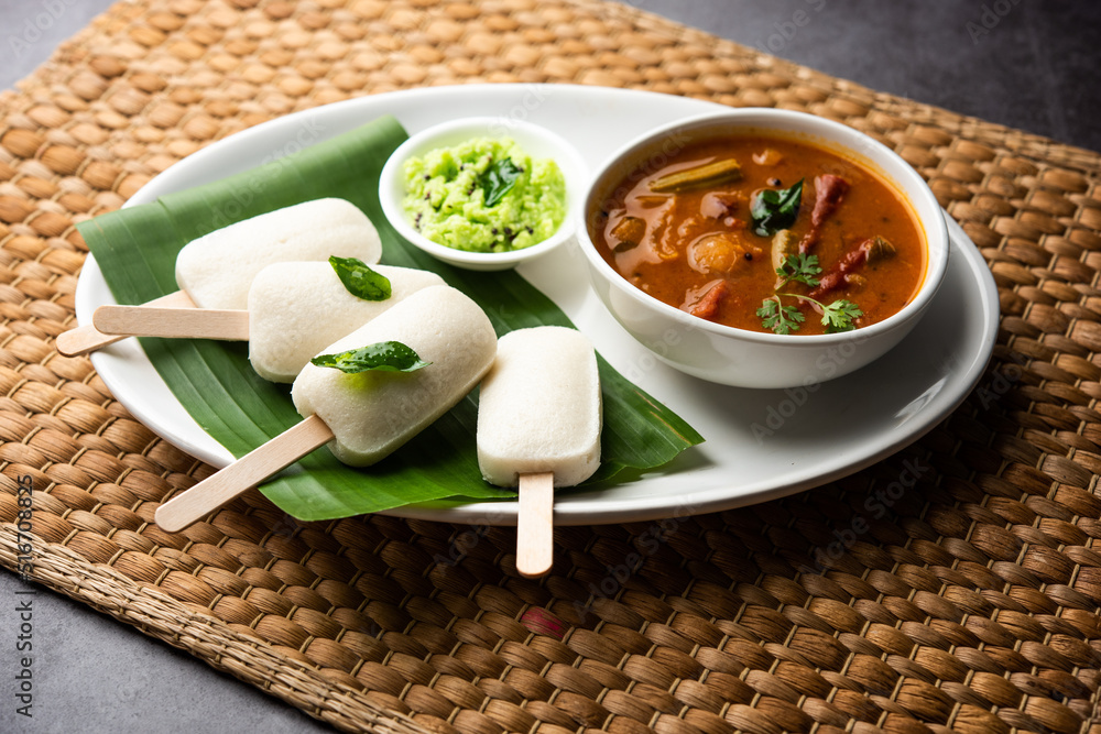 Idly lollipop or idli candy with stick served with sambar and chutney ...