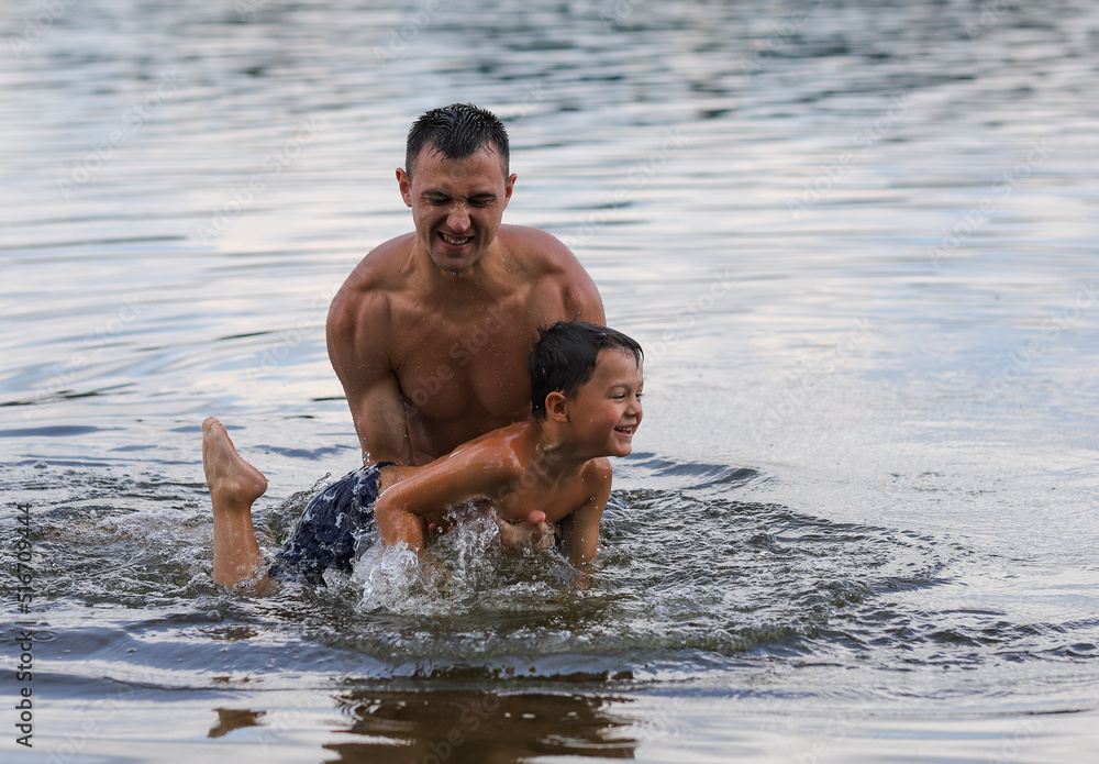 father and son swim in a pond Stock Photo | Adobe Stock