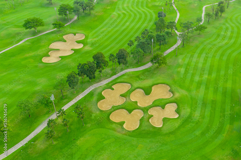 Aerial view of green grass and trees on a golf field, fairway and ...