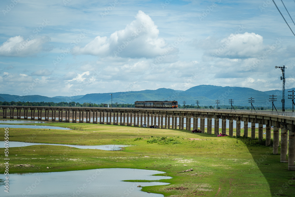 The train is running on the electric train with bridge over river Stock ...