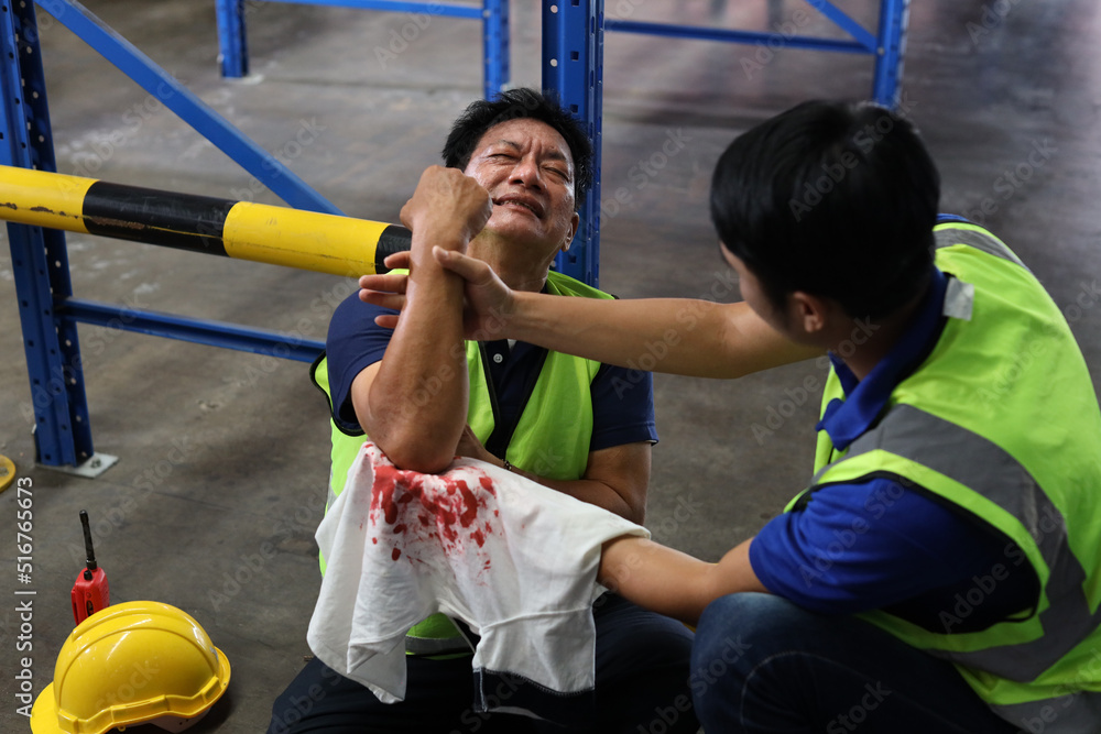 Middle aged warehouse asian worker man had elbow accident sitting on ...