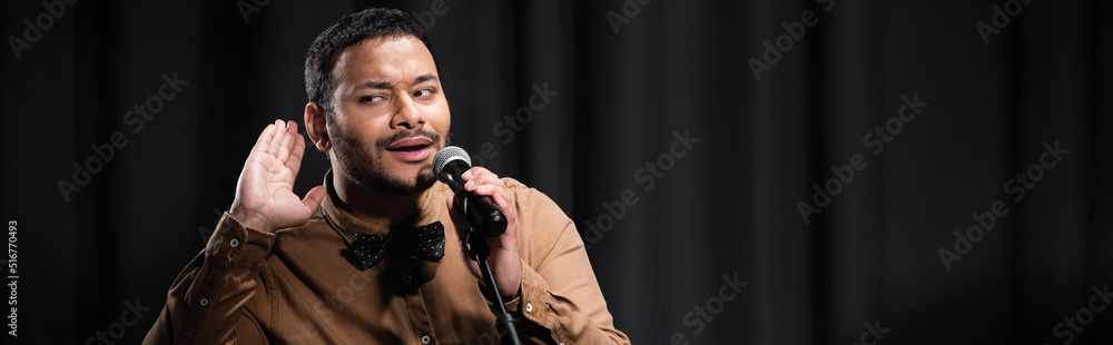 indian comedian listening and performing stand up comedy into ...