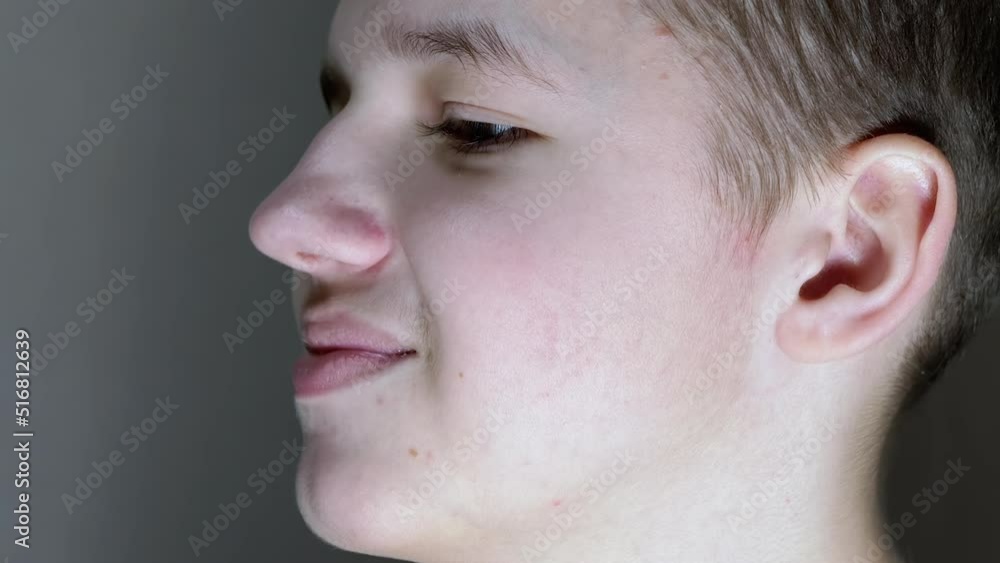 Close-up of a Face Profile of Talking Smiling Teenager Looking Down ...