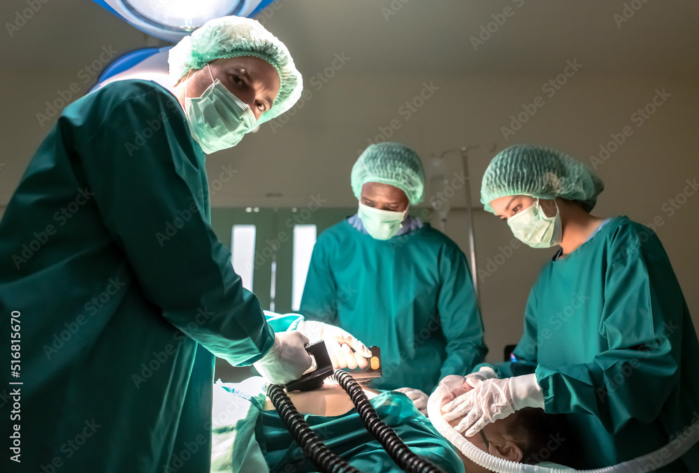 Surgeon doctor and surgery teamwork using defibrillator in operating ...