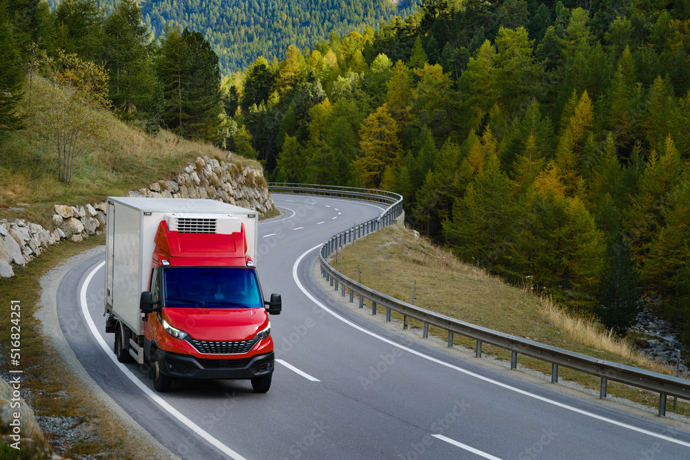 Urban delivery refrigerator box truck with red cabin driving on a ...