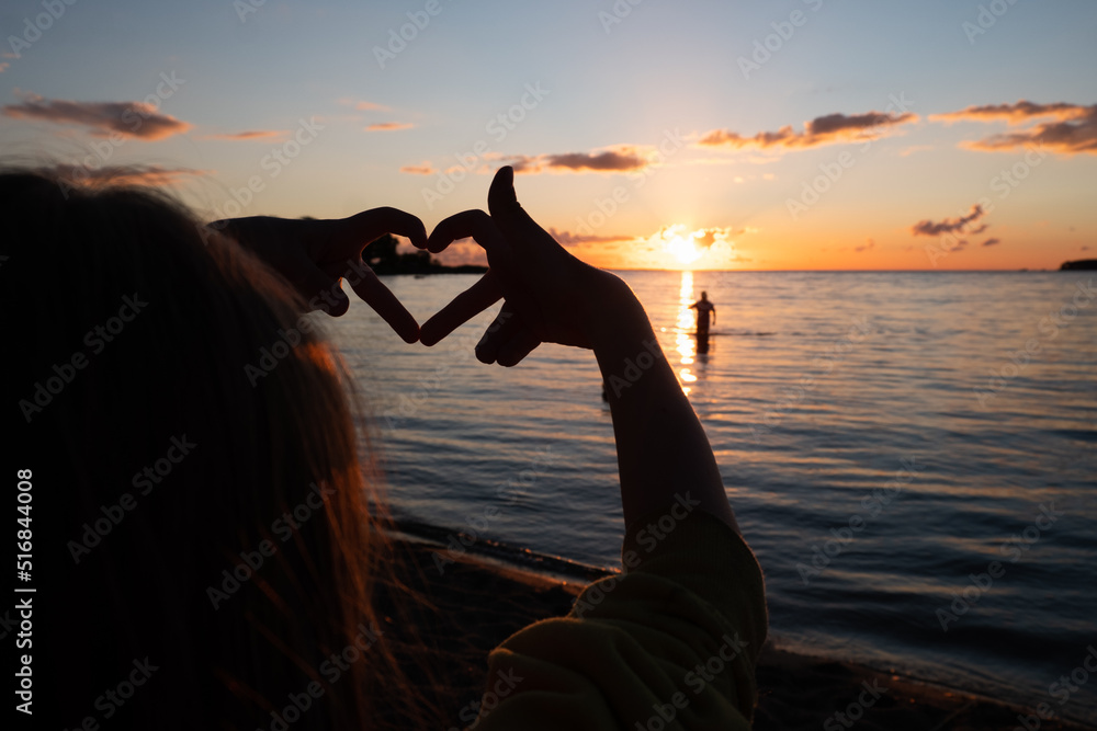 Heart shape hand gesture made with fingers against colorful out of ...
