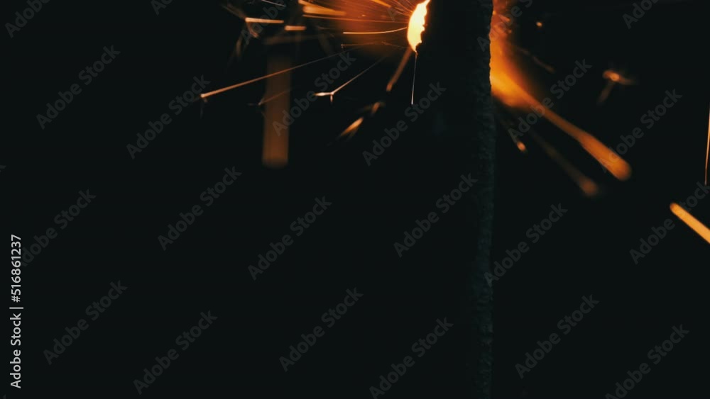 Lightening sparkler on black background in slow motion, macro shot ...