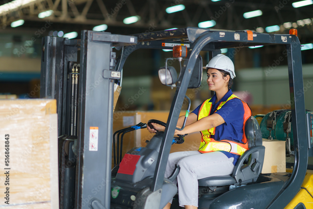 Asian beautiful woman driver drive fork lift car in industry with smile ...
