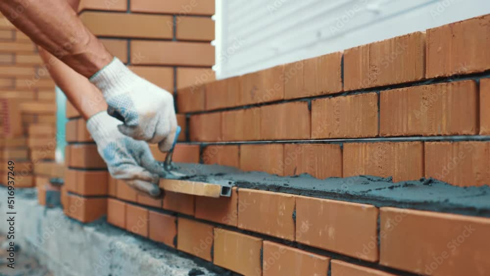 Vídeo do Stock: Worker or mason hands laying bricks close up ...