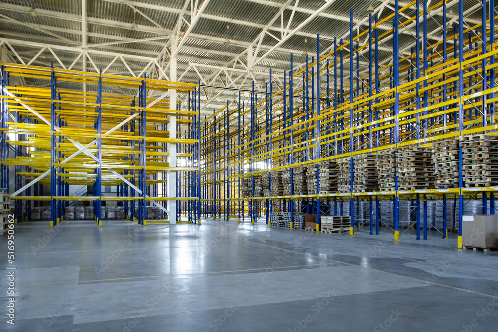 Interior of a modern warehouse storage of retail shop with pallet truck ...