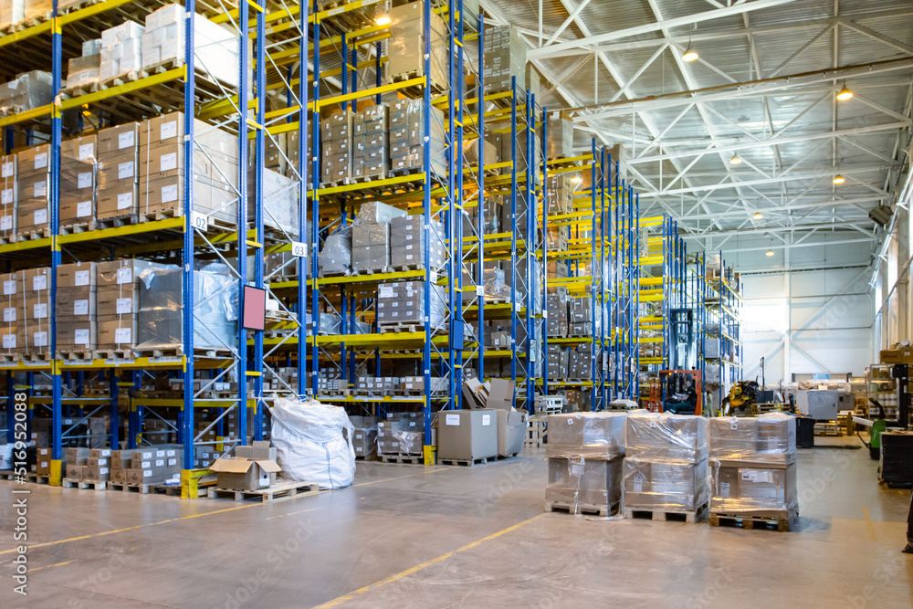 Interior of a modern warehouse storage of retail shop with pallet truck ...