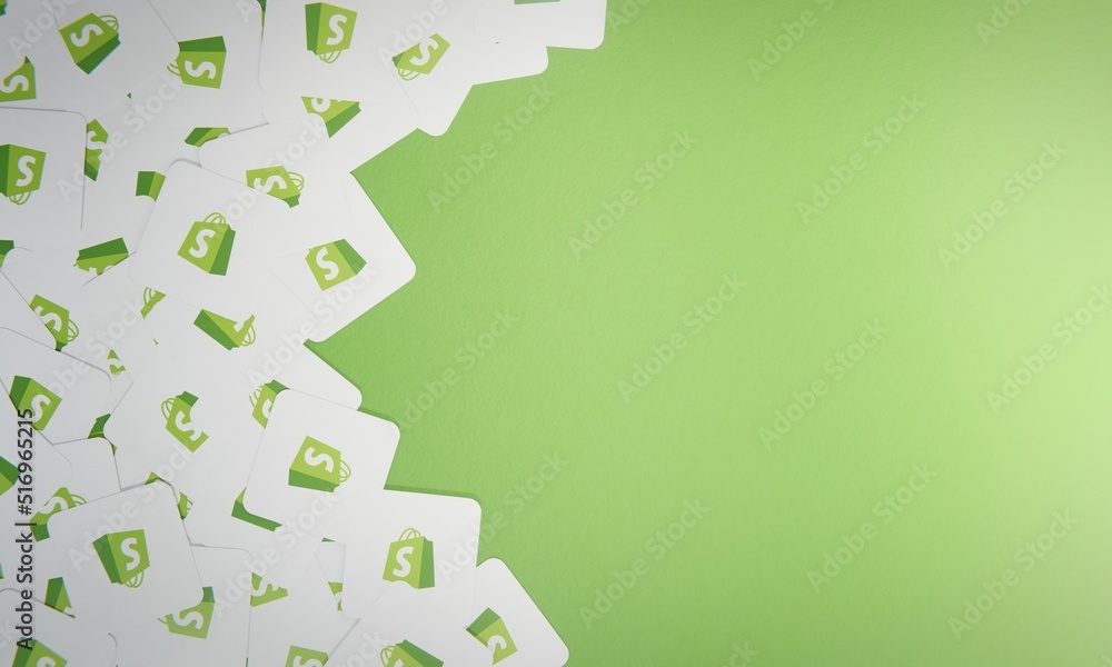 Shopify logo on paper cards layed out in a heap on flat surface Stock ...