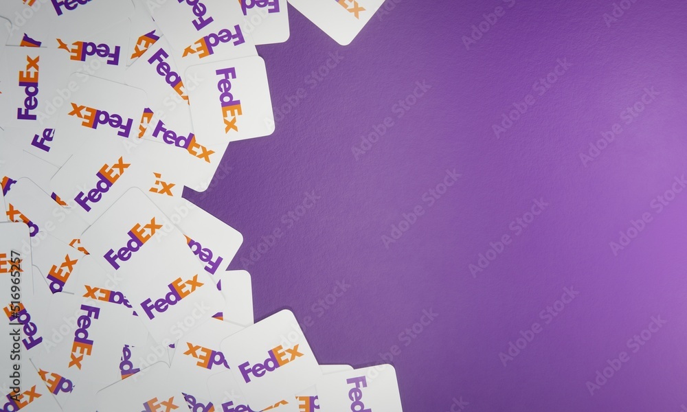 FedEx logo on paper cards layed out in a heap on flat surface Stock ...