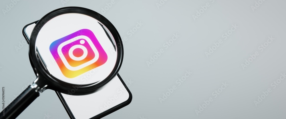 Instagram logo on smartphone under magnifying glass. Editorial ...