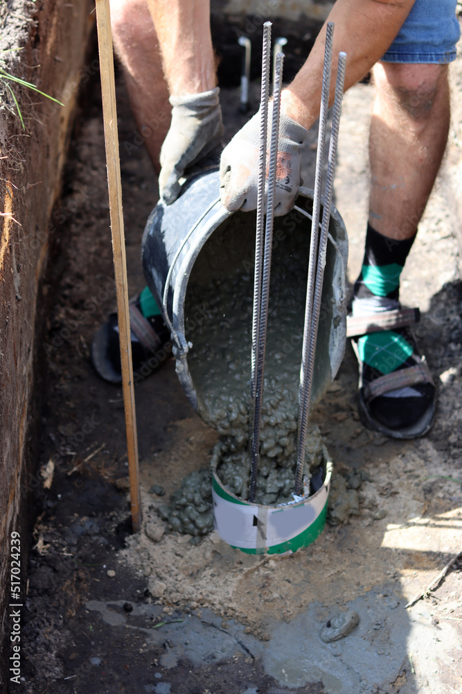 Cement work in progress. Foundation strength work. Bucket of concrete ...