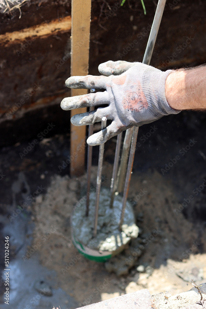 Cement work in progress. Foundation strength work. Bucket of concrete ...