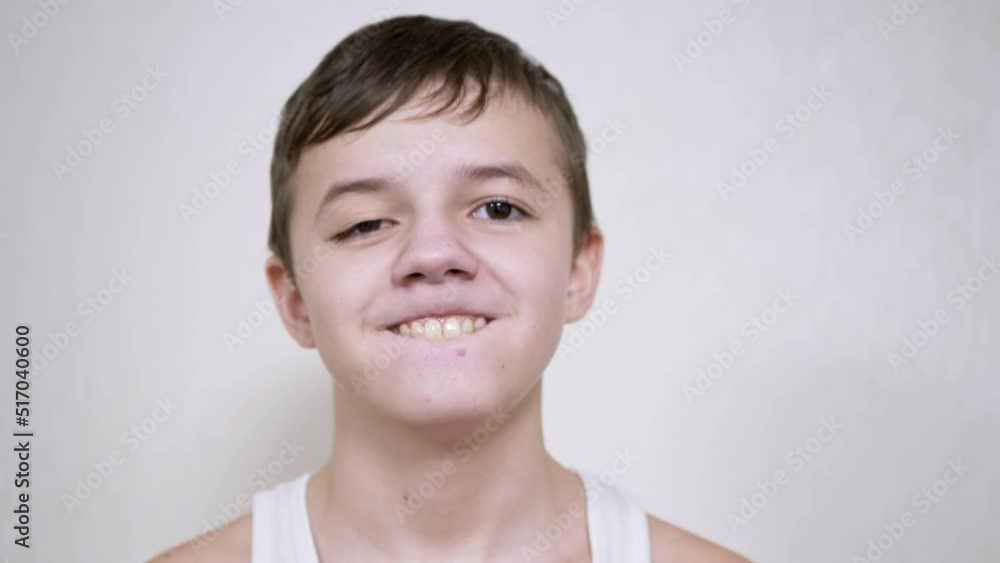 Smiling Teenager Gesticulates with Mouth, Showing his Teeth, Tongue. A ...
