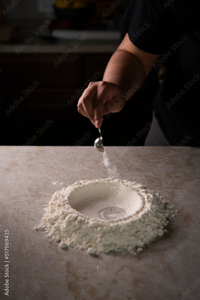 Adding salt to the flour Stock Photo | Adobe Stock