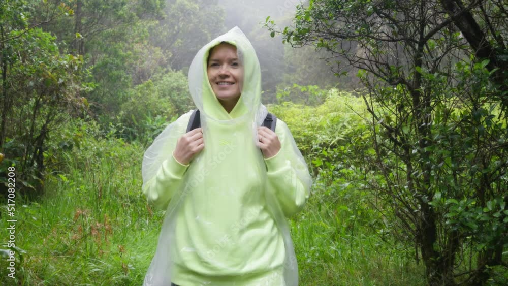 Happy hiker, childhood concept in the pouring rain, wet season in fern ...