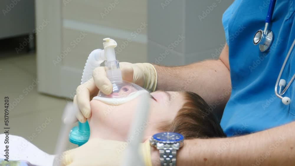 Little child under anaesthesia. Breathing mask on boy face. Health care ...