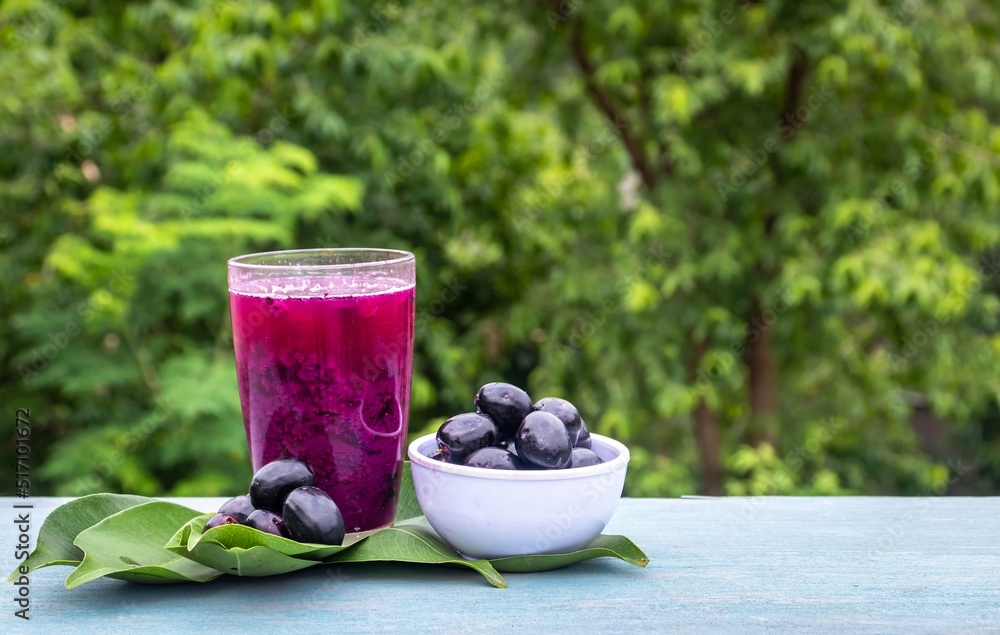 Jamun or Black Plum Juice in a Glass with Fruit in a Bowl with Leaves ...