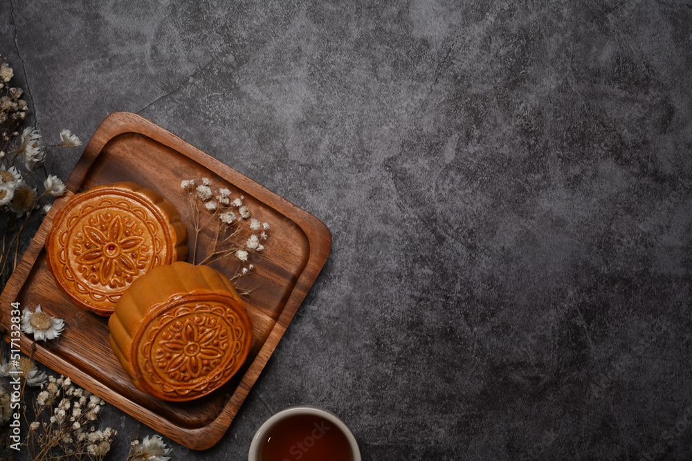 Above view Chinese moon cake for Mid Autumn festival and tea on rustic ...