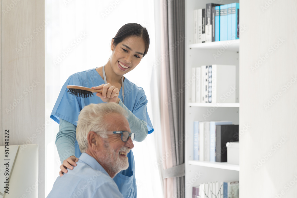 Nurse and patient old man. Female nurse combing hair of old man at ...