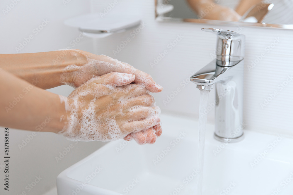 Washing hands under the flowing water tap. Hygiene concept hand detail ...